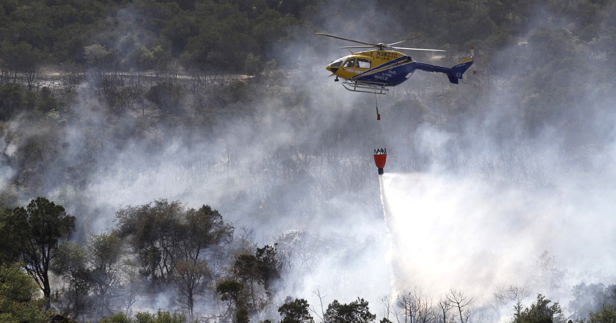 Texas wildfires reach Austin, threaten to spread - CBS News
