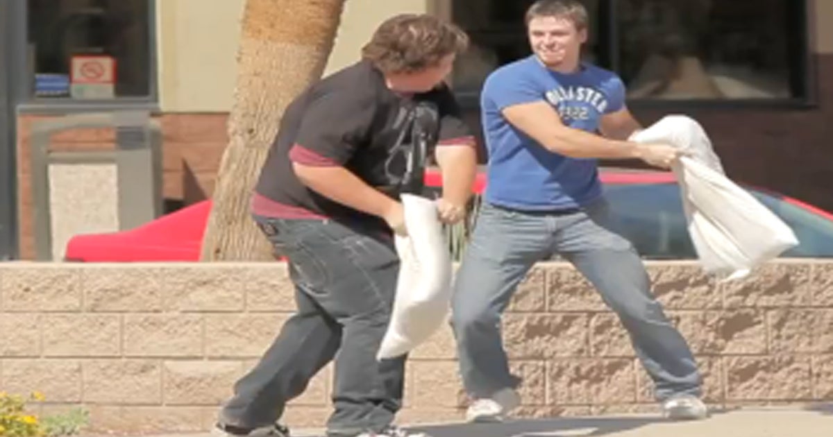 Random pillow fight breaks out on the streets - CBS News