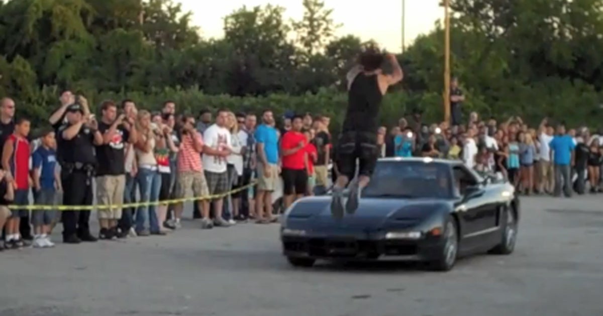 Man performs amazing flip over a speeding car - CBS News