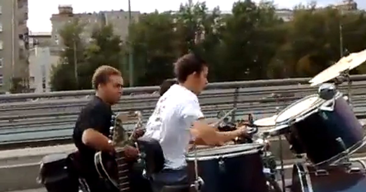 Band literally rocks a motorcycle on the highway - CBS News
