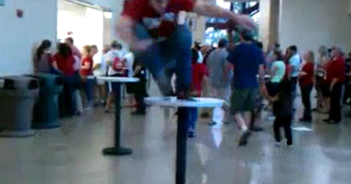 Guy attempts to jump over table, fails miserably - CBS News