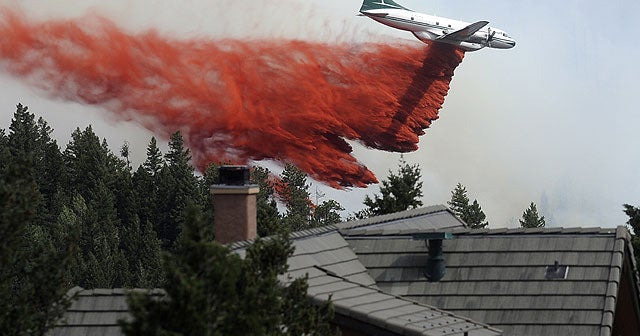 Wildfire victims crowd shelters as fight continues - CBS News