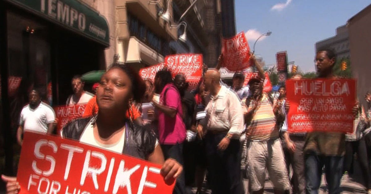 Thousands of fast food workers strike for higher pay - CBS News