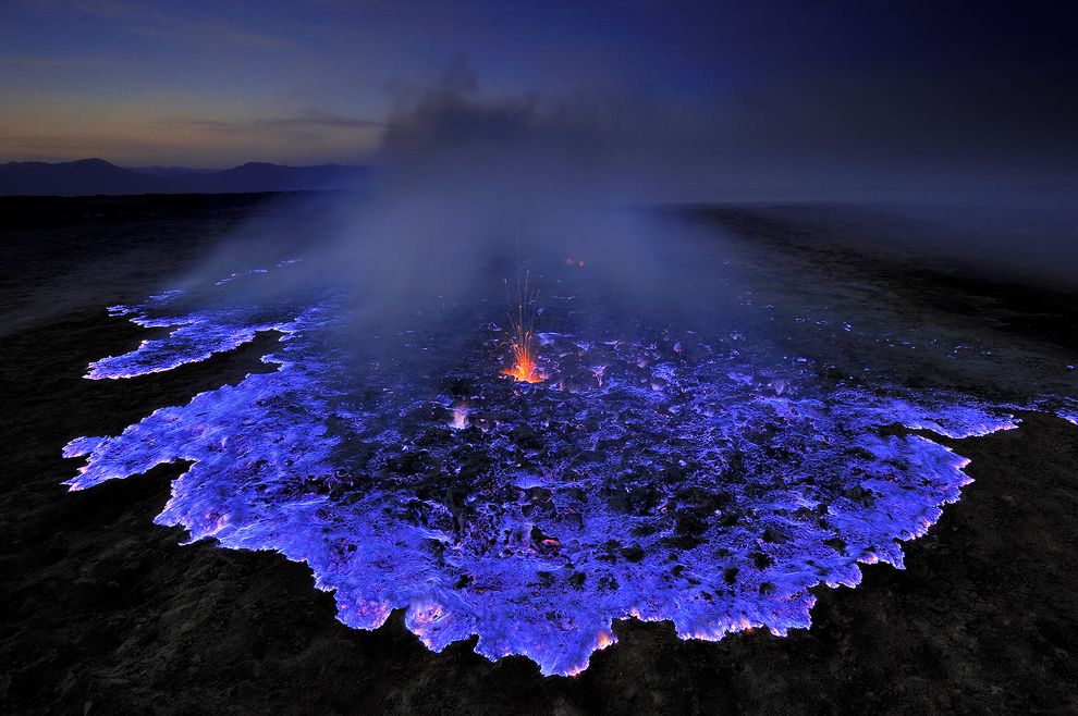 Volcano erupts in bright blue flames: Stunning photos - CBS News