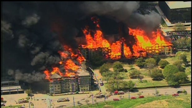 Massive fire engulfs apartment complex in Houston - CBS News