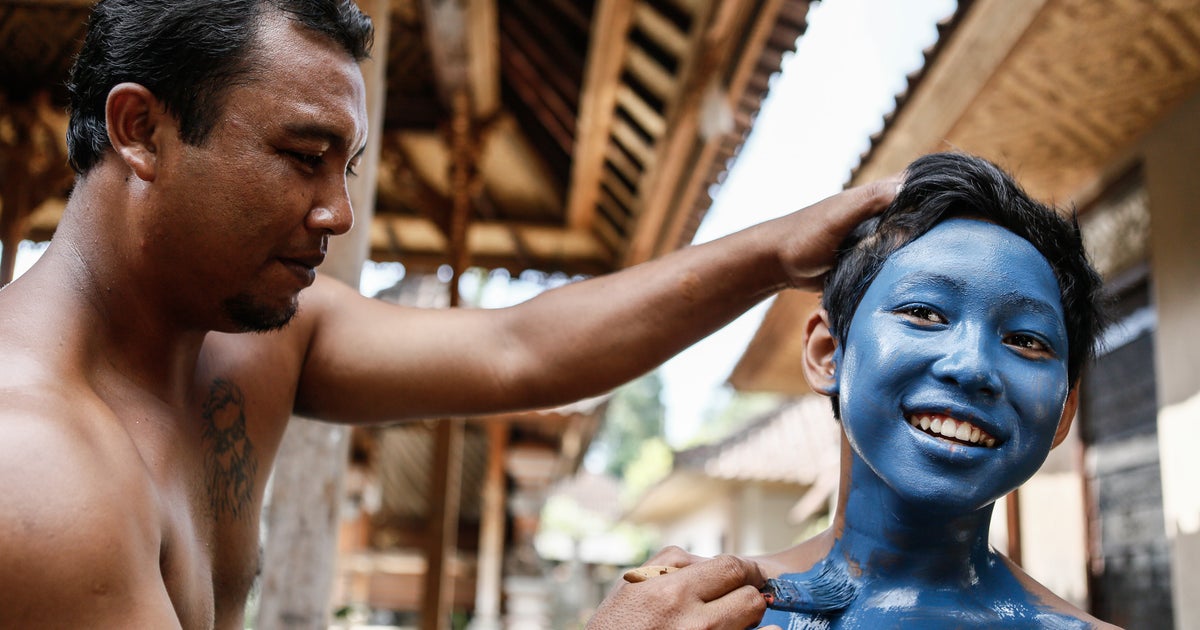 Painted parade wards off evil in Bali