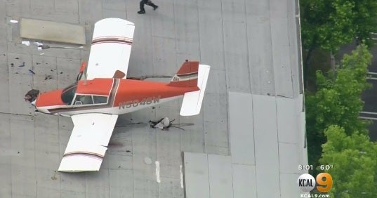 Small plane crash lands on roof of building in Southern California ...