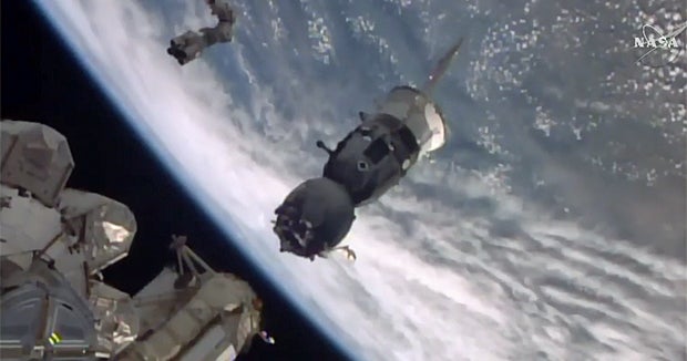 Soyuz capsule brings three space station fliers back to Earth - CBS News