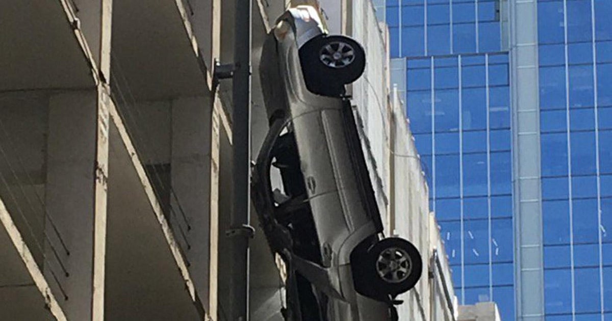 Car dangles off parking garage in downtown Austin - CBS News