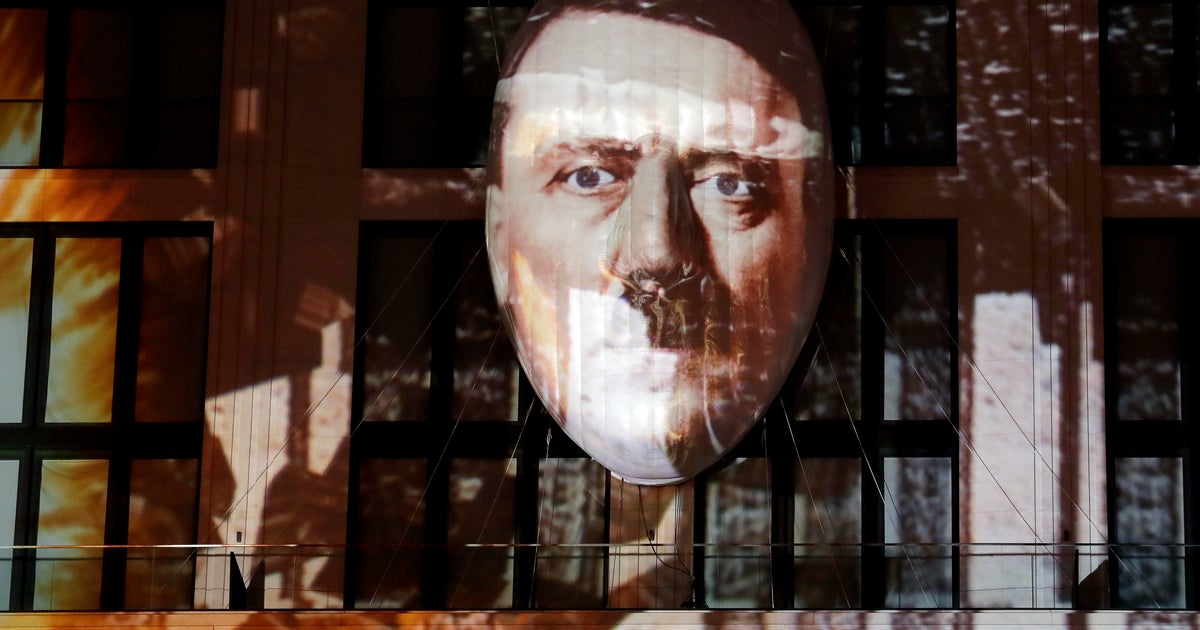 Giant laughing Adolf Hitler image projected on Berlin building scares ...