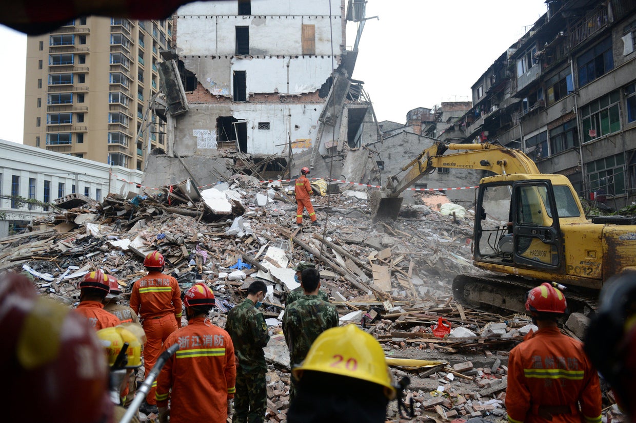 China girl survives collapse of home in arms of her dead parents - CBS News