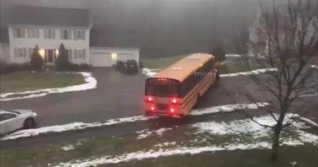 Out-of-control school bus slides down icy street, hits car in ...