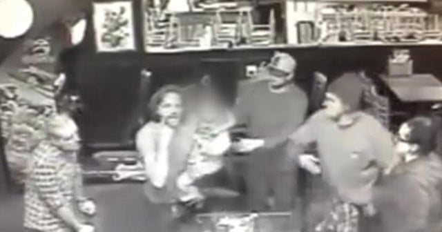Video shows man holding child during violent bar fight - CBS News
