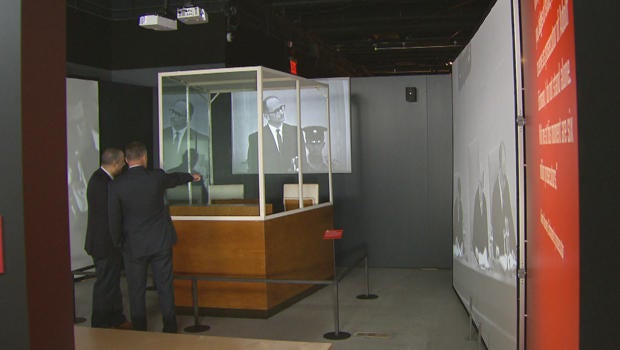 The man in the glass booth - CBS News