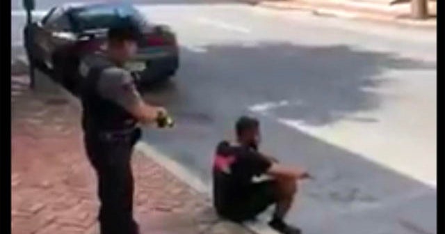 Video shows officer using stun gun on man sitting on sidewalk - CBS News