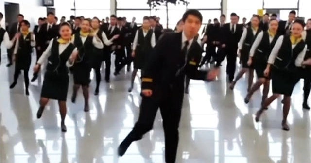 Chinese flight attendants dance during travel rush - CBS News