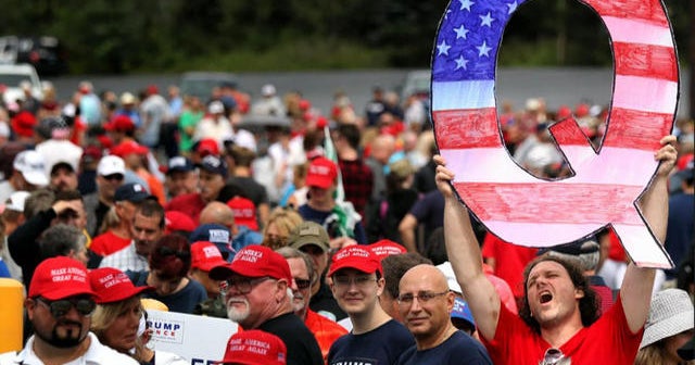 QAnon's conspiracy theories seep dangerously into the real world - CBS News