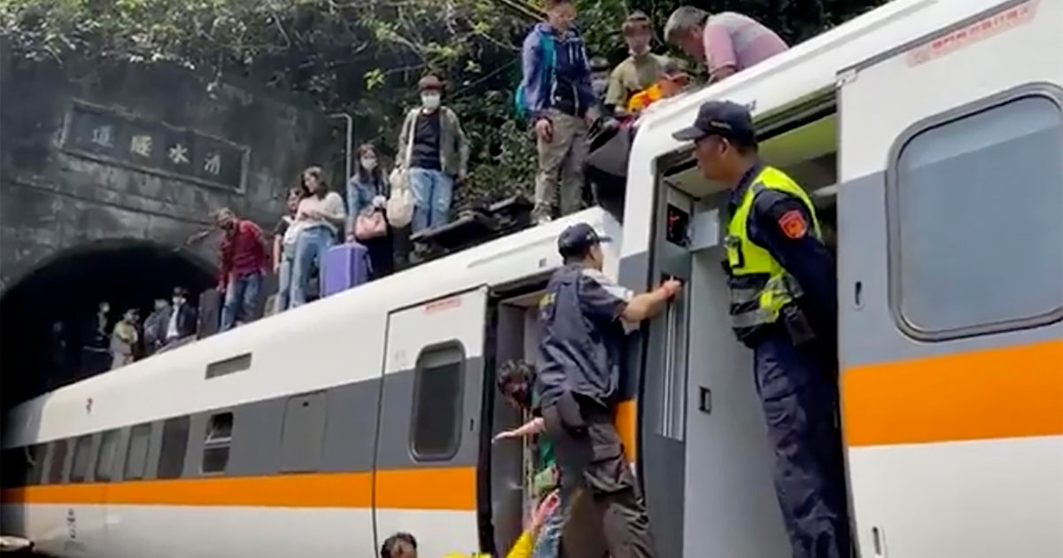 Dozens killed as train crashes into truck and partially derails in ...