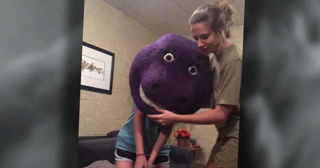 Teenage girl gets head stuck in Barney mask - CBS News
