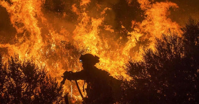 Thousands flee growing wildfire in California - CBS News