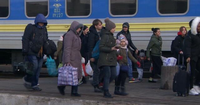 As hundreds of thousands of Ukrainians flee, many choose to stay behind ...