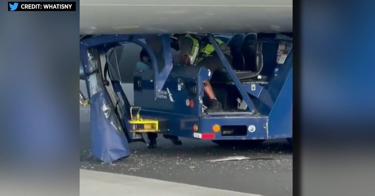 Airplane tug crushed underneath plane at LaGuardia Airport - CBS New York