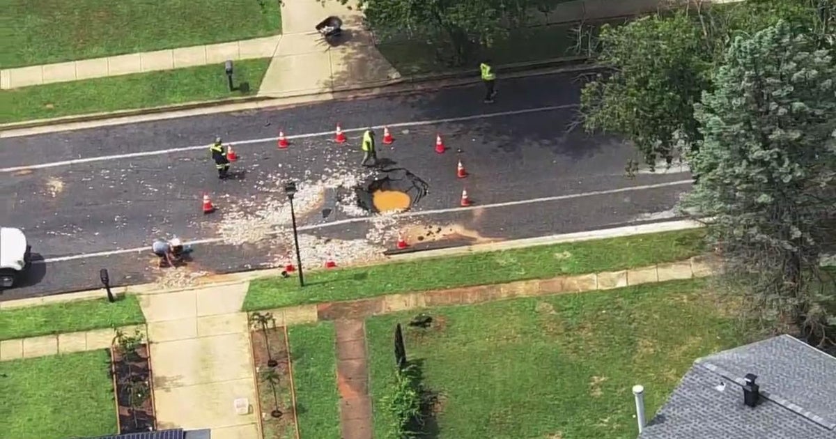 Water main break leaves residential Owings Mills street damaged - CBS ...