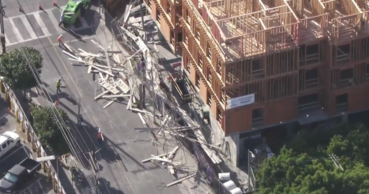 Worker injured, car damaged after scaffolding collapses off of building ...