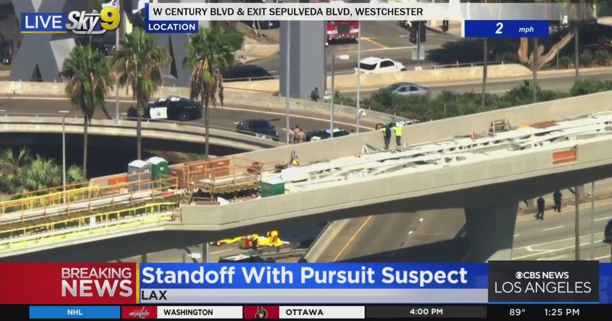 Standoff with pursuit suspect, firefighters setting up airbag in case ...