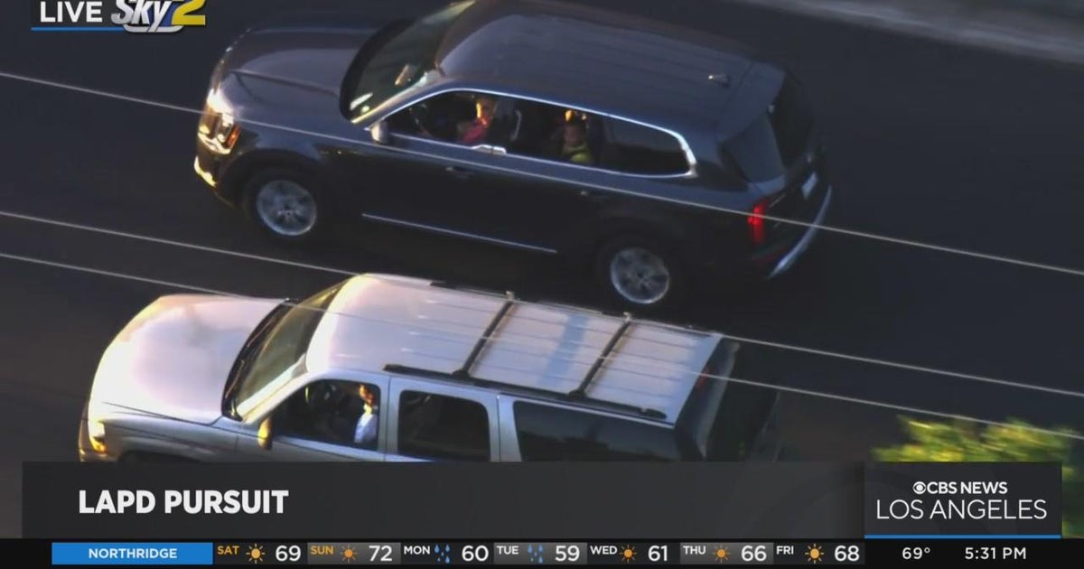 Pursuit suspect drives along side separate vehicle, appears to talk to ...