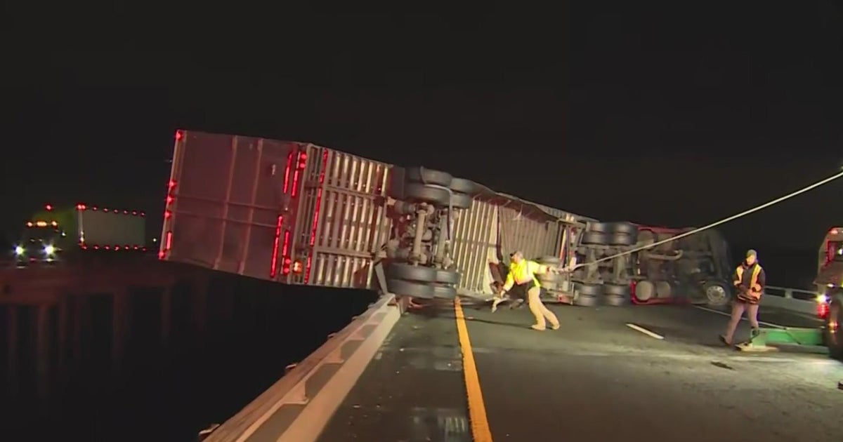 Winds blow over big rig, leaving it partially hanging over Yolo Bypass ...