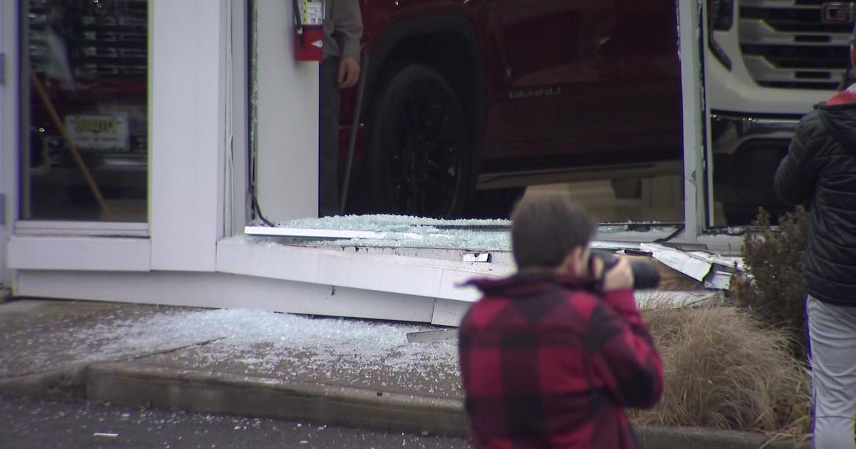 Driver slams into New Jersey car dealership - CBS New York