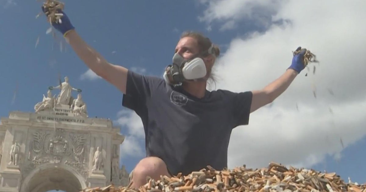 Climate activist stages protest in Lisbon over pollution from cigarette ...