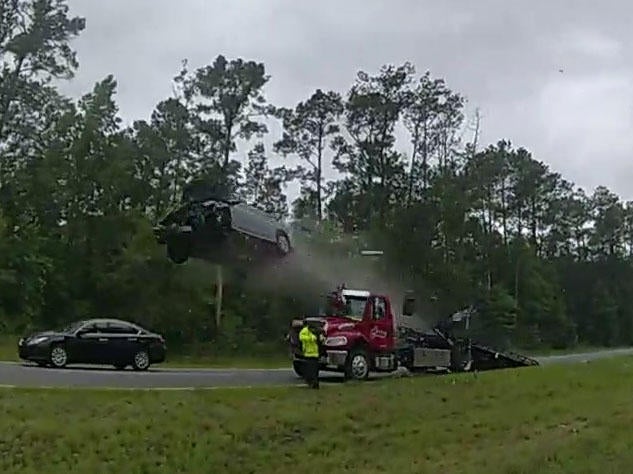 Car launches off tow truck, crashes onto Georgia highway in video - CBS ...