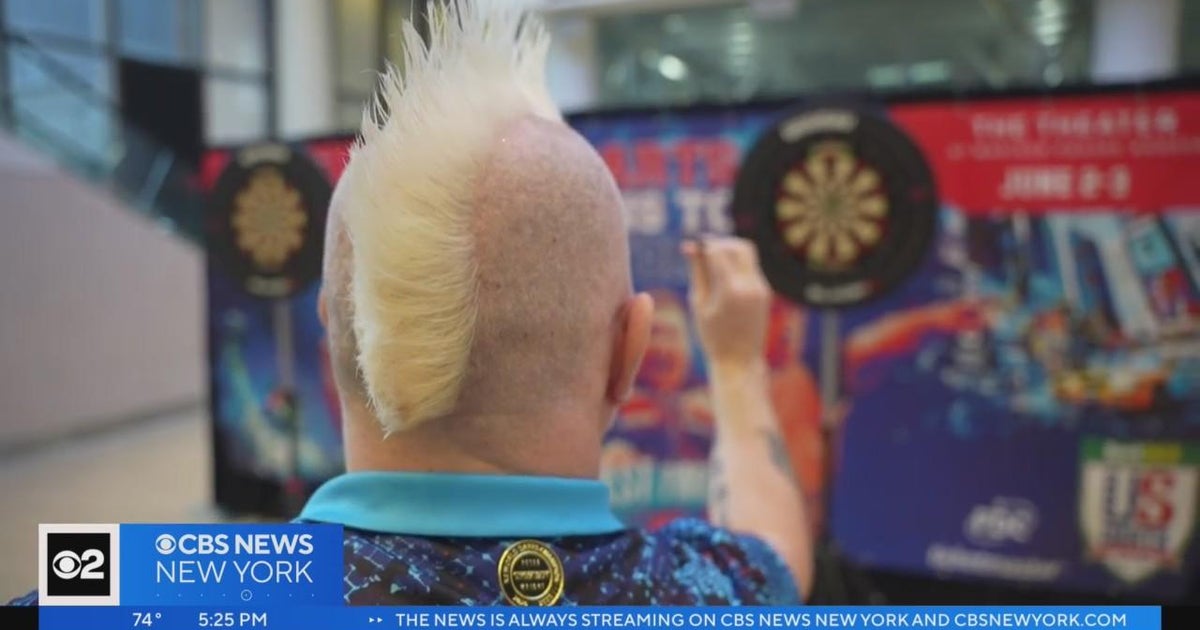 Meet "Snakebite," a double world champion professional dart player ...