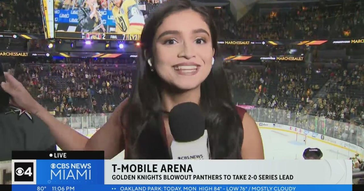 CBS News Miami's Samantha Rivera jostled by a rowdy hockey fan - CBS Miami