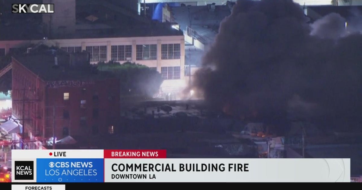 Commercial building fire continues to rage at textile warehouses in ...