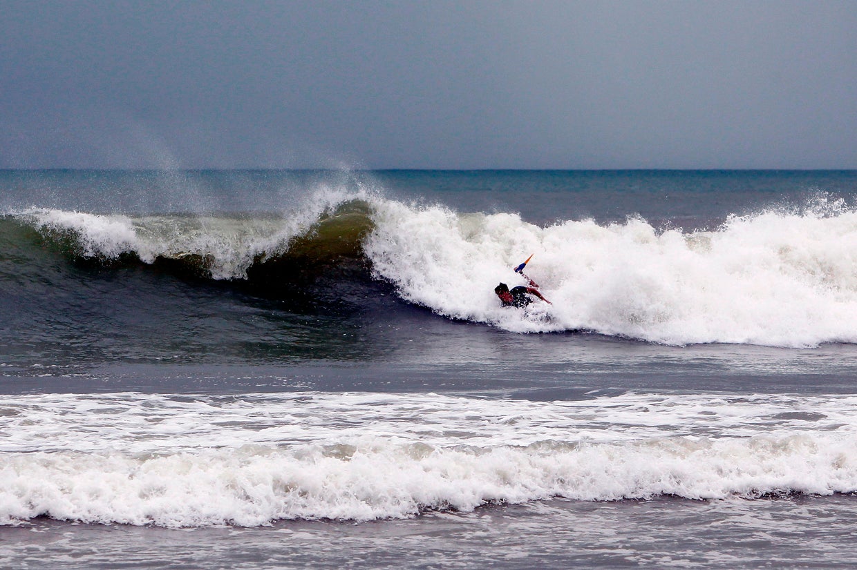 "It's really dangerous": Surfers face "chaotic" waves and storm surge ...