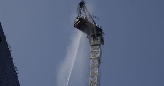 Crane catches fire, partially collapses in New York City - CBS News