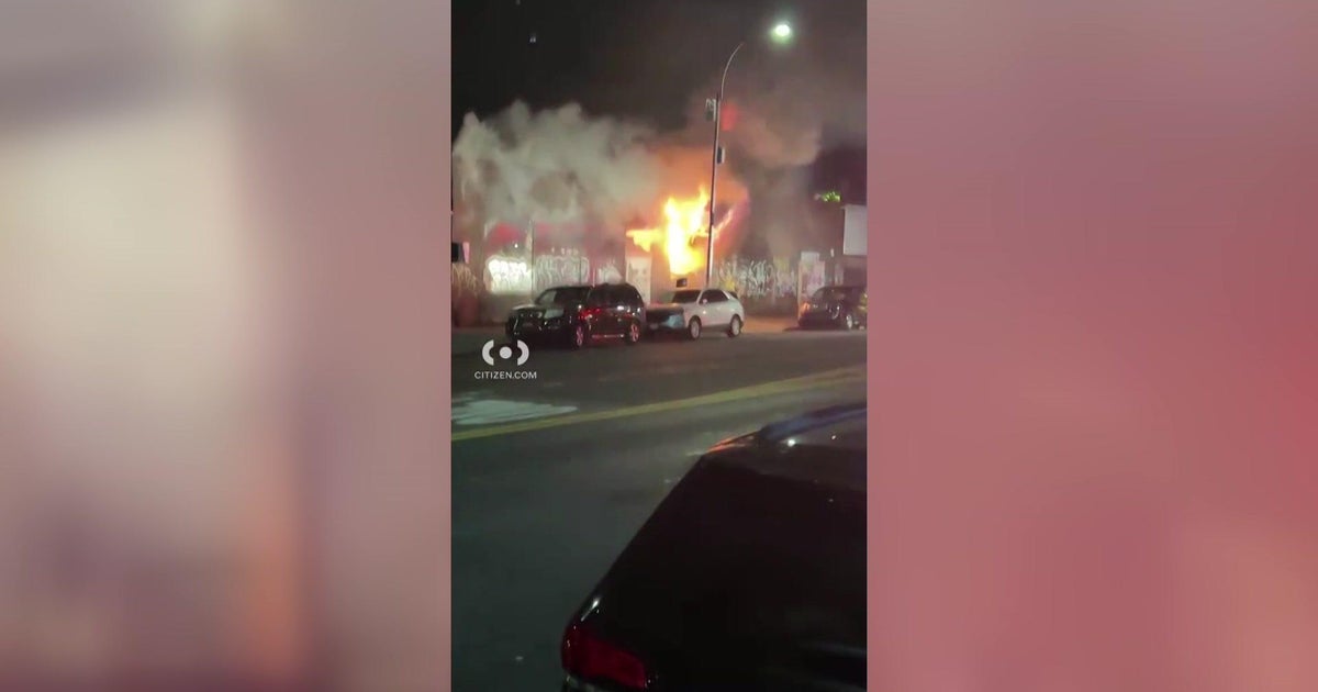 Crews battle fire at vacant car dealership in Queens - CBS New York