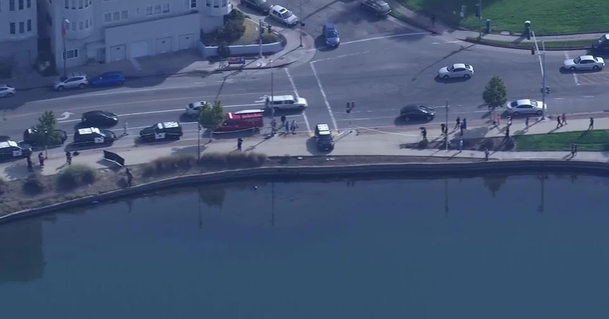 Raw video: Body found inside a suitcase floating in Oakland's Lake ...