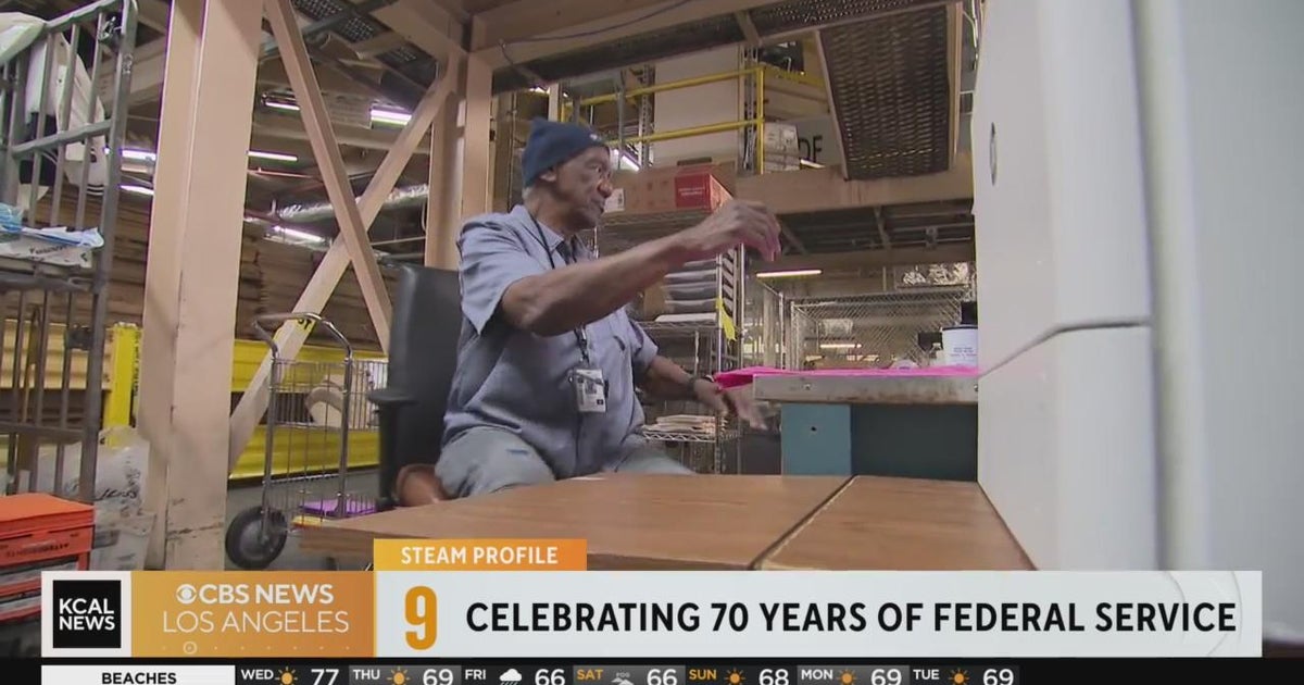 Leroy Brown, a US Postal Service clerk, welcomes the technology used at ...