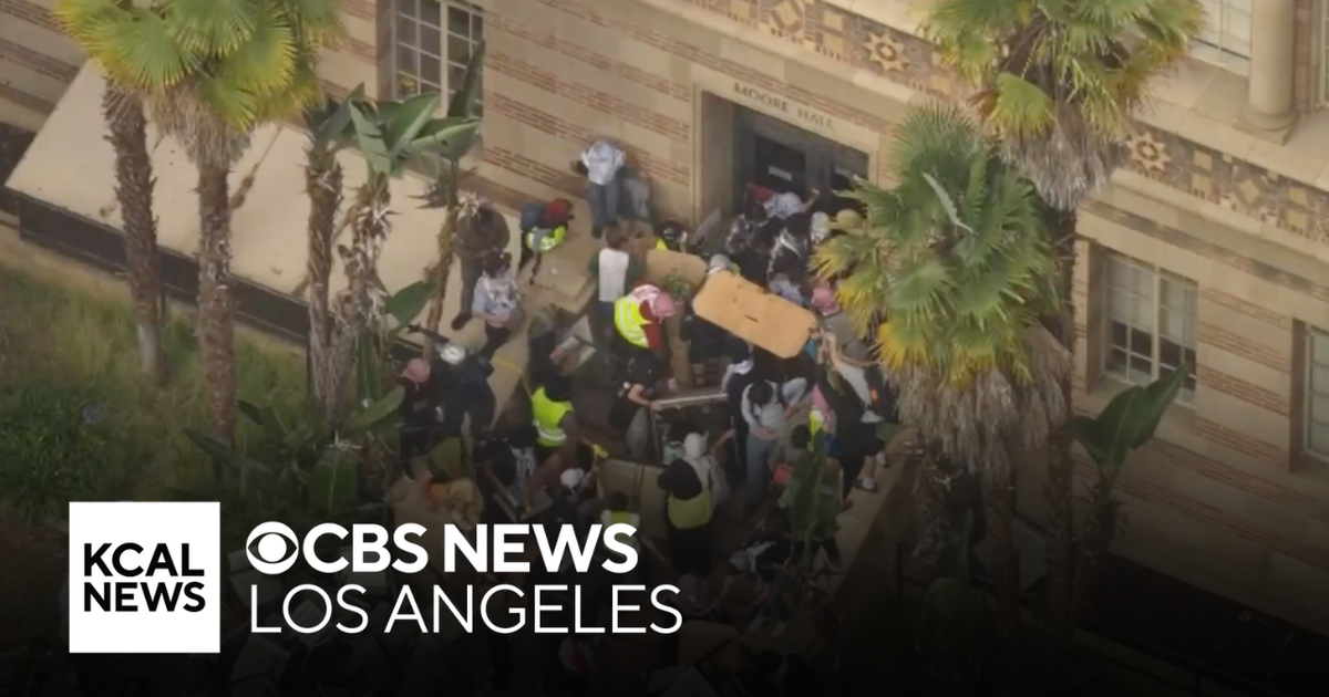 Protesters barricade near Moore Hall on UCLA campus as police surround ...