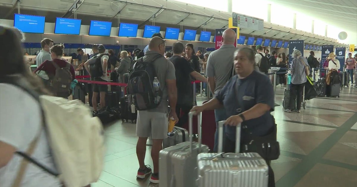 Travelers wait as global outage sparks flight delays, cancellations at ...