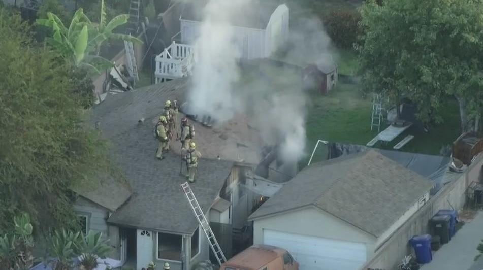 Firefighters rescue a person trapped in a Downey house fire - CBS Los ...