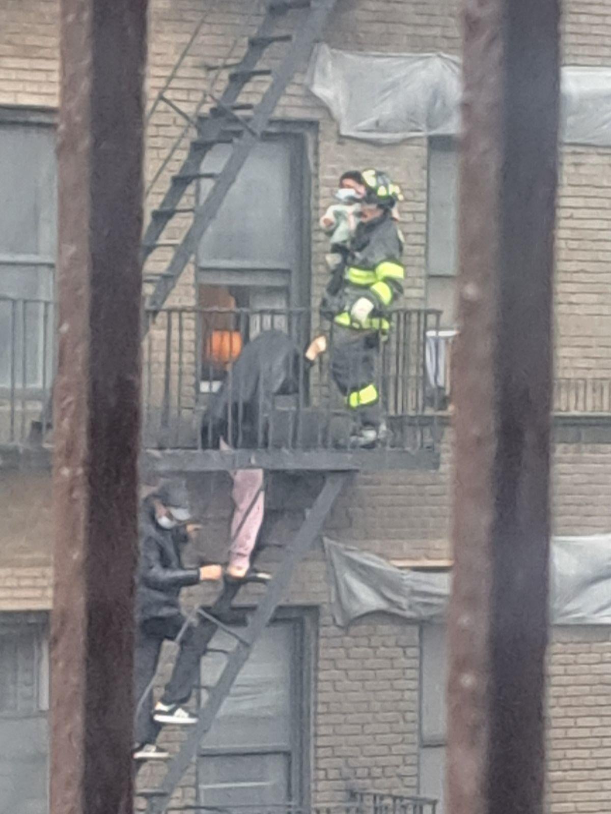 Photos capture rescue of child from Inwood apartment fire in NYC - CBS ...