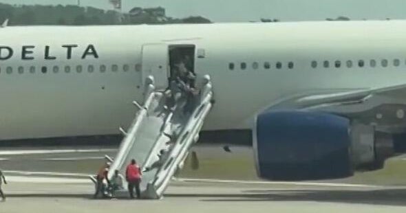 Passengers evacuate on slide after Delta plane engine catches fire at ...