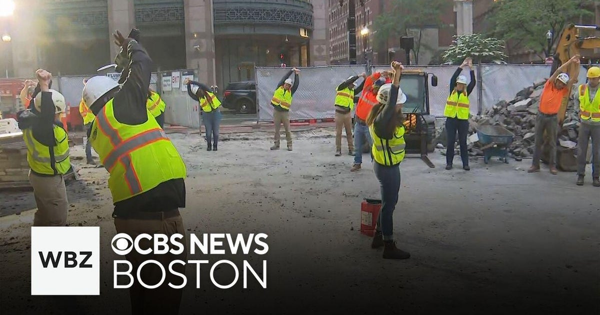 Boston construction workers stretch and flex before starting their day ...