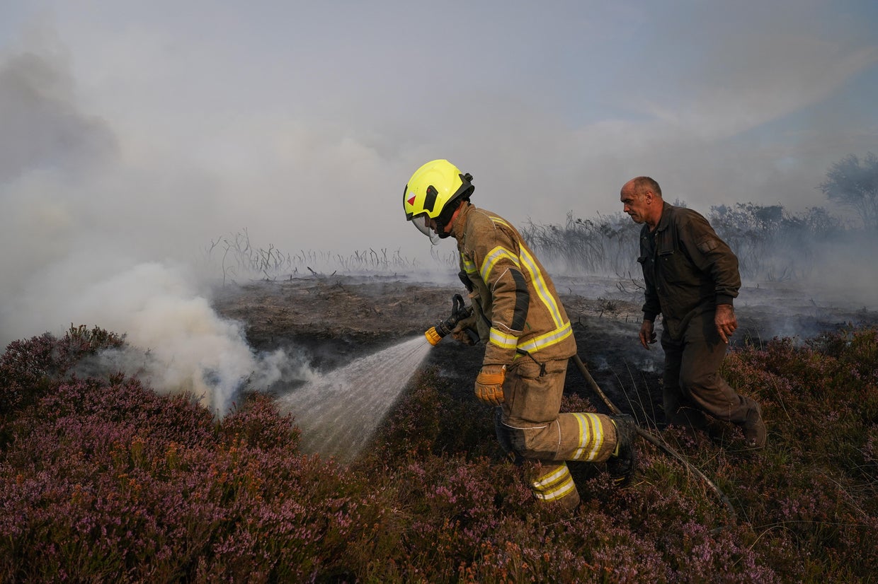 Crews battling wildfire in English countryside face added risk of ...