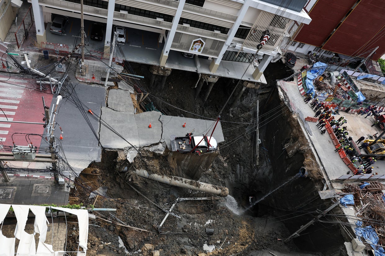 Massive sinkhole swallows part of a Bangkok road, forcing evacuations ...